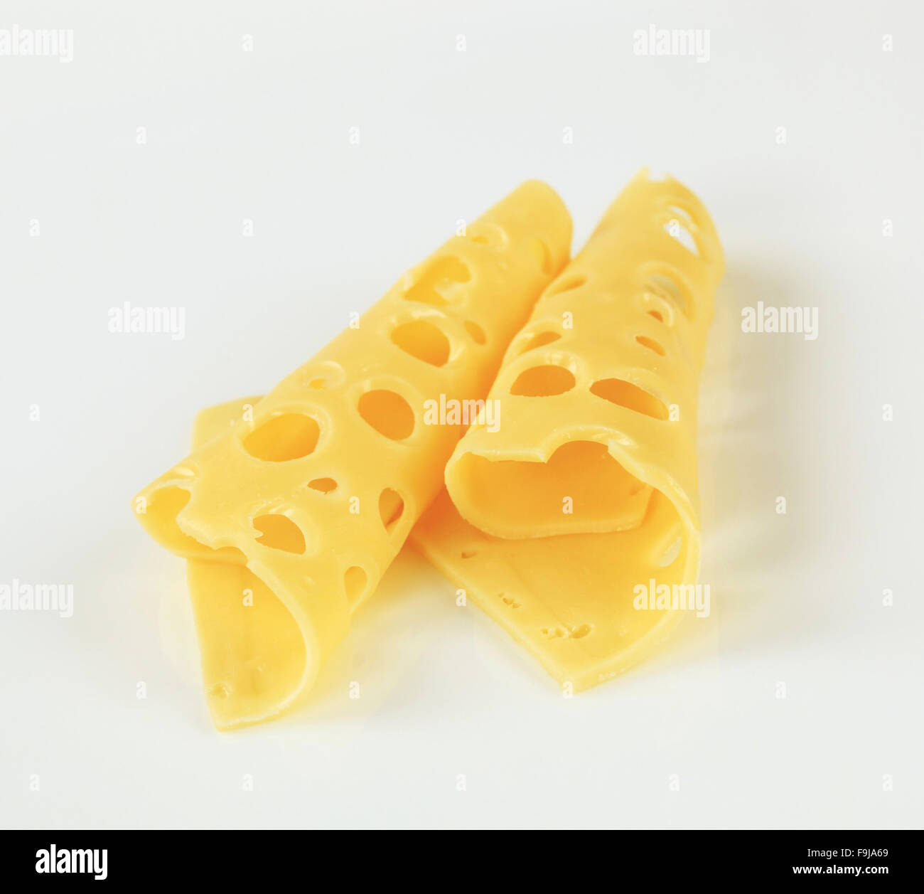 Thin slices of Swiss cheese - studio Stock Photo - Alamy