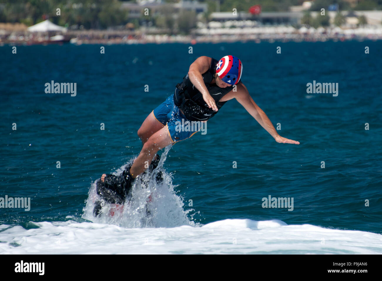 Flyboarder falling into sea to his left Stock Photo - Alamy