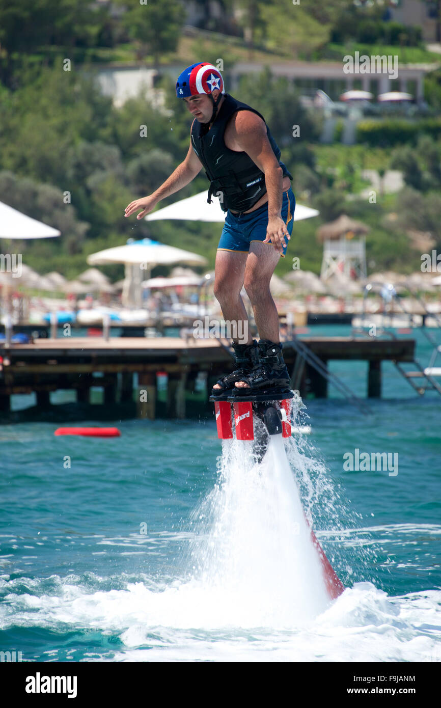 Flyboarder with his arms out beside dock Stock Photo - Alamy