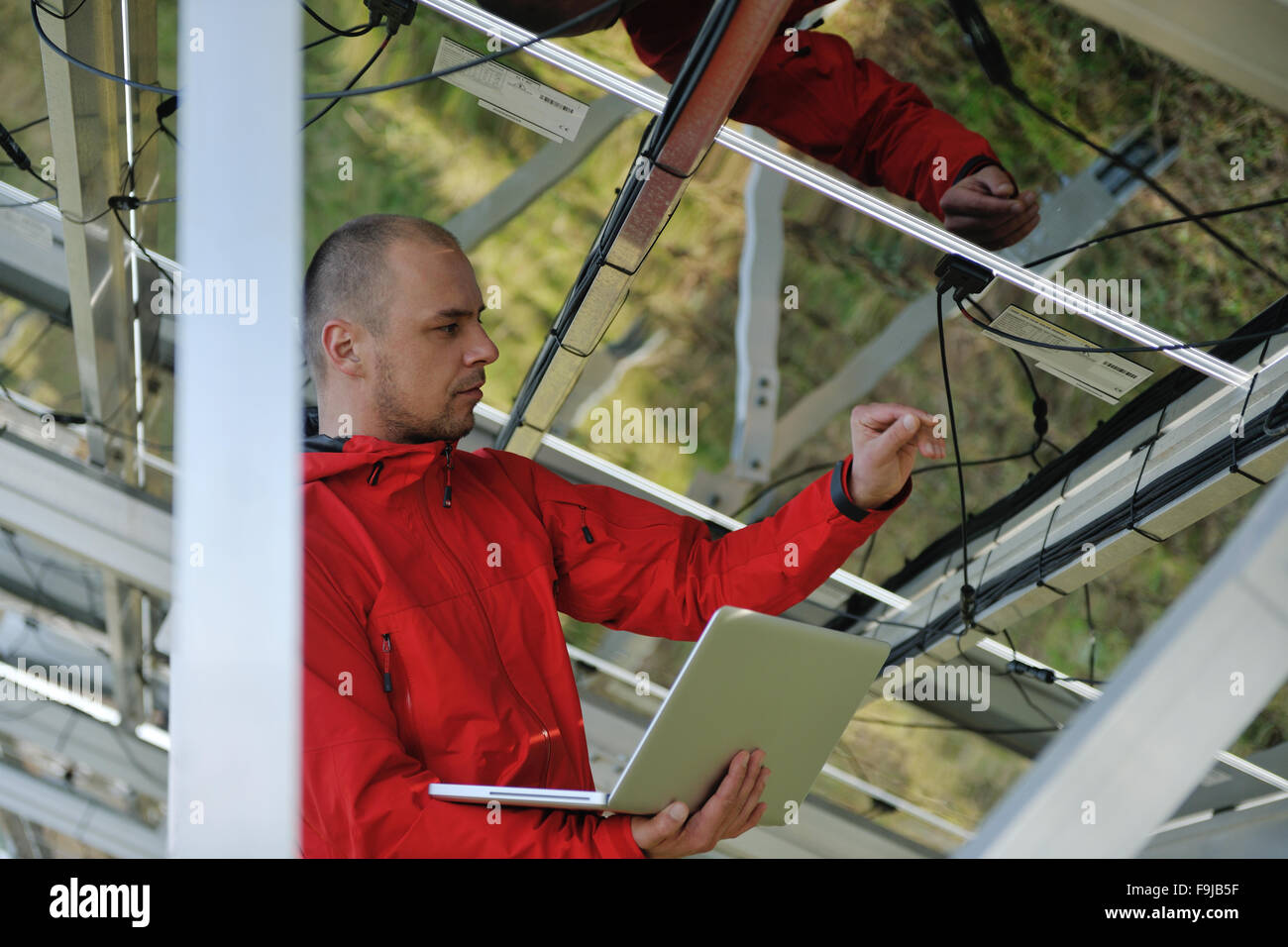 business man engineer using laptop at solar panels plant eco energy ...