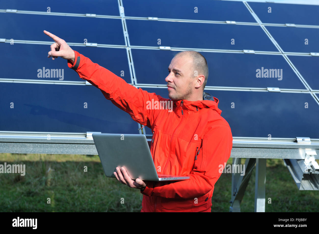 business man engineer using laptop at solar panels plant eco energy ...