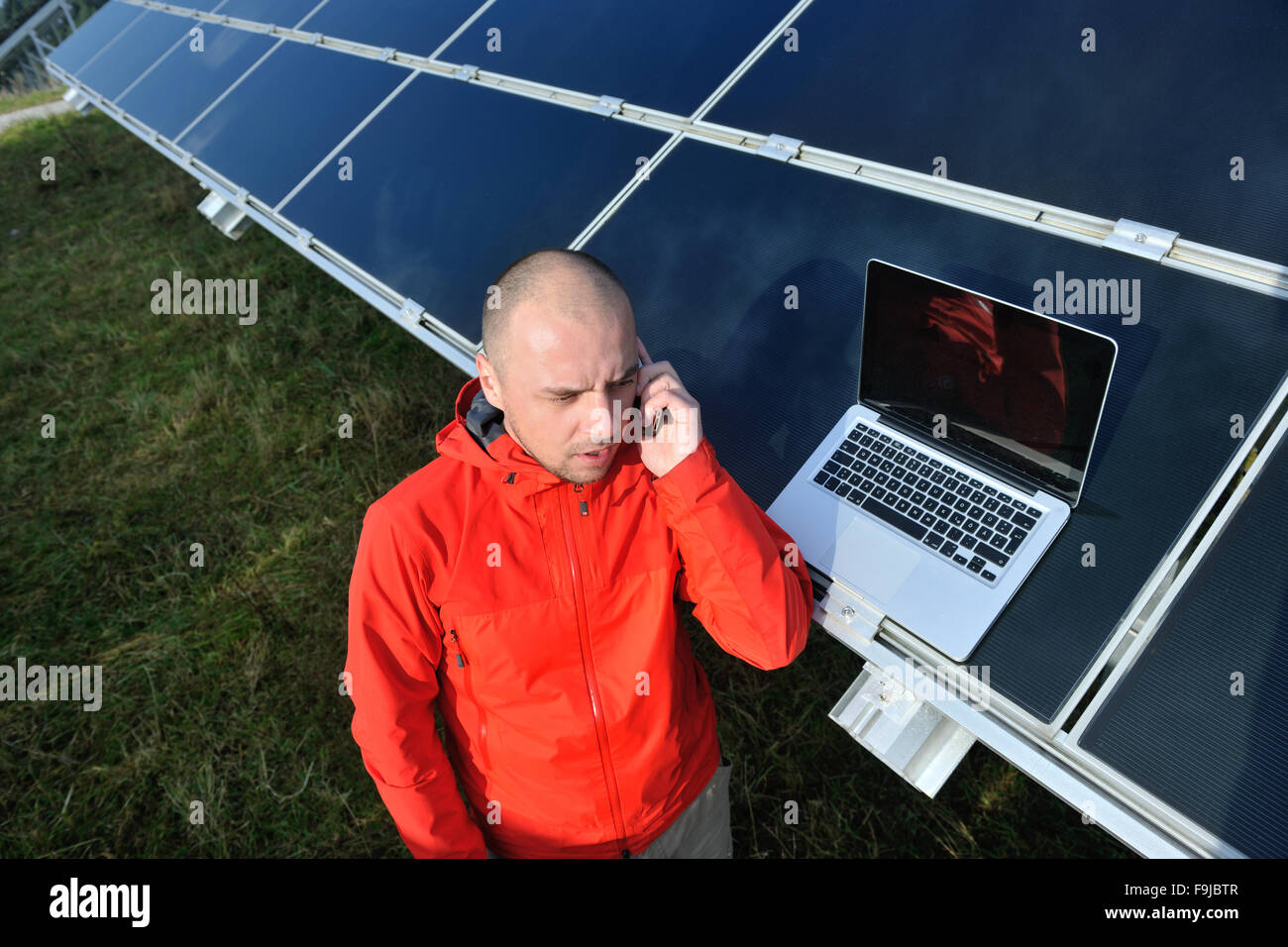 business man engineer using laptop at solar panels plant eco energy ...