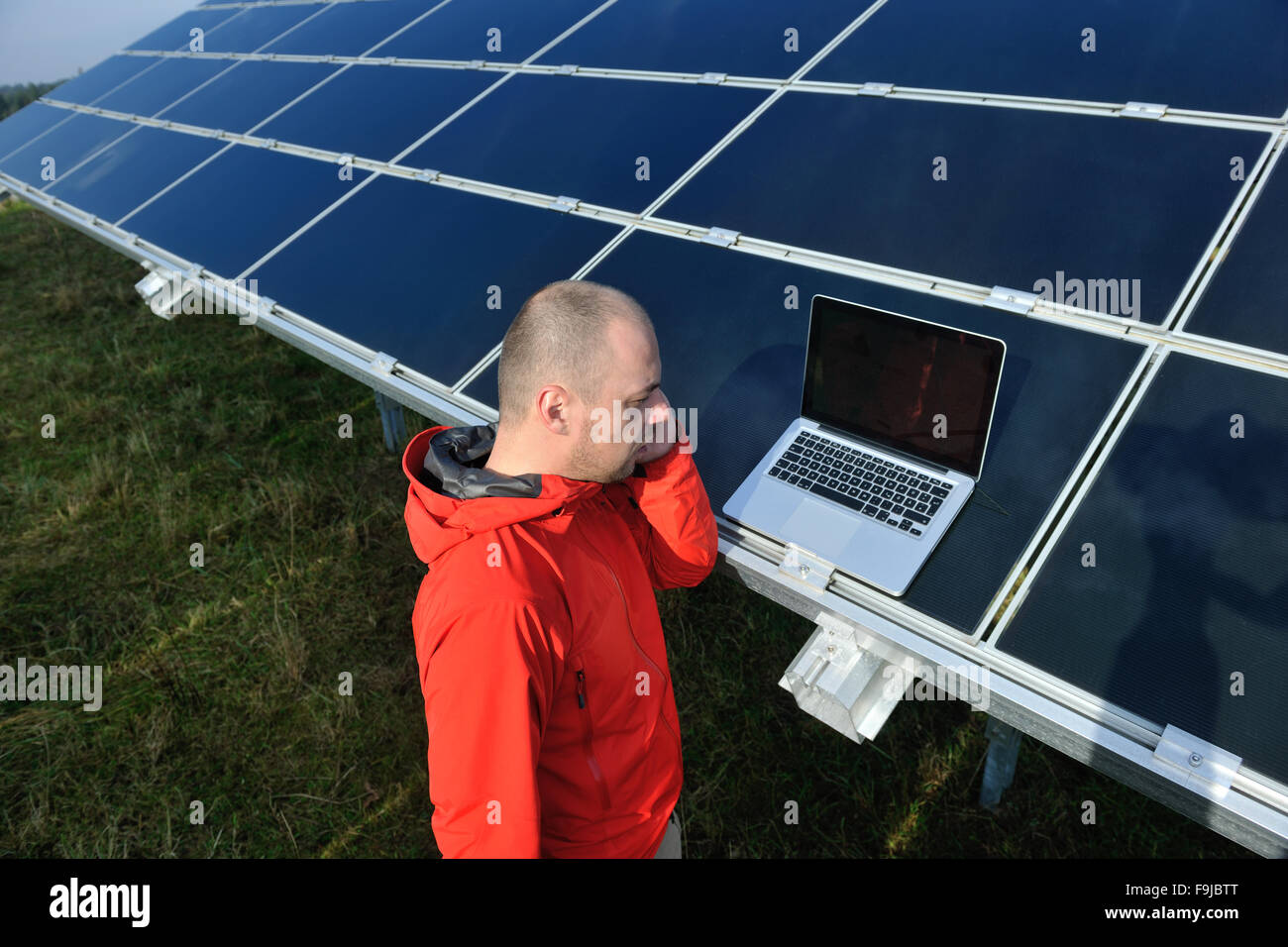 business man engineer using laptop at solar panels plant eco energy ...