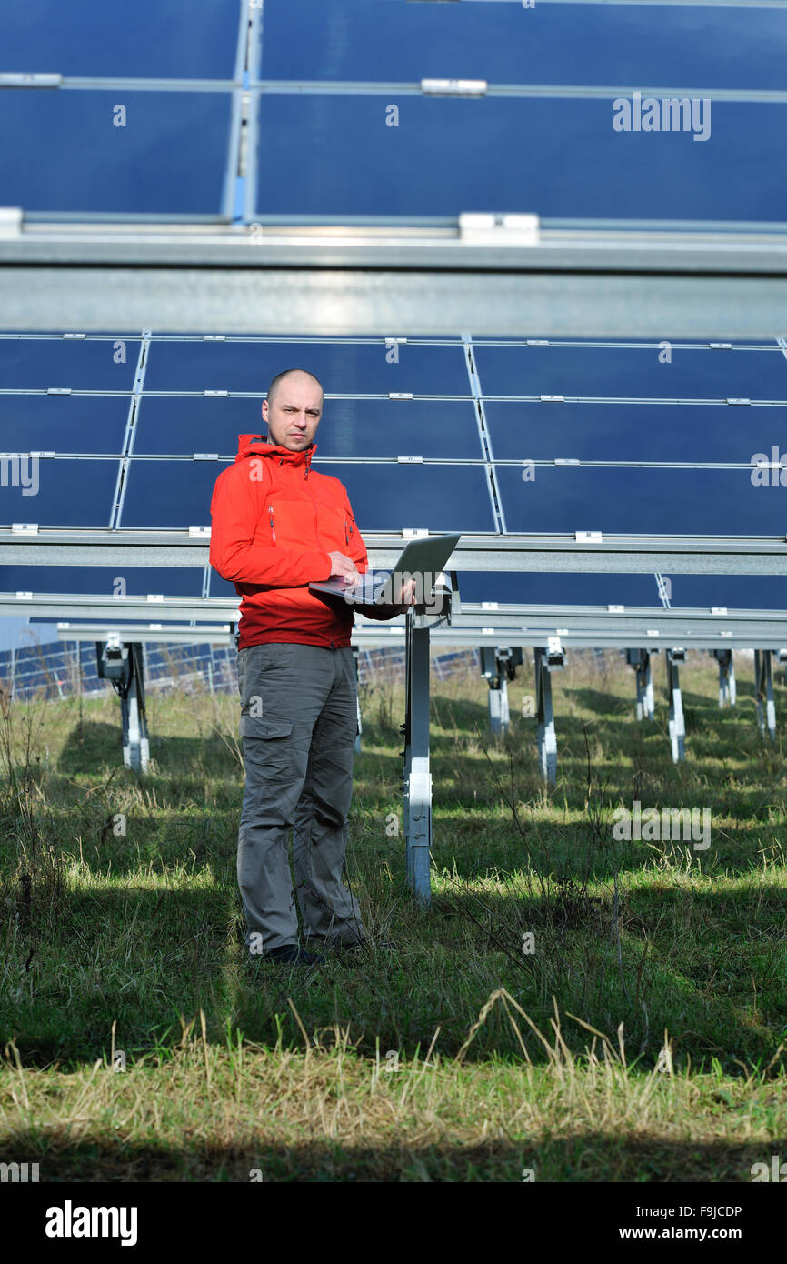 business man engineer using laptop at solar panels plant eco energy ...