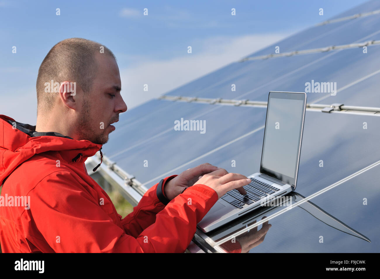 business man engineer using laptop at solar panels plant eco energy ...