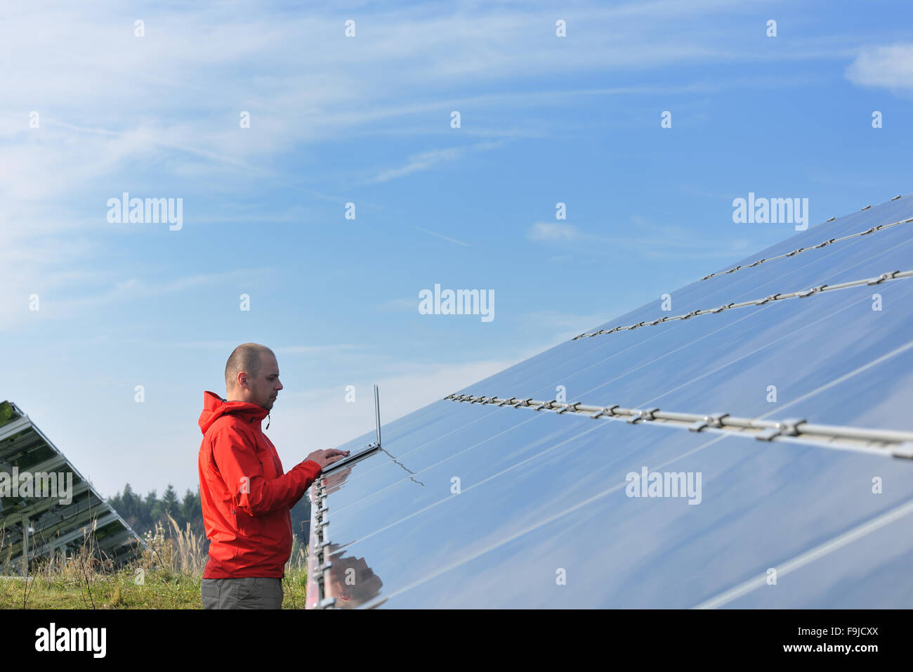 business man engineer using laptop at solar panels plant eco energy ...