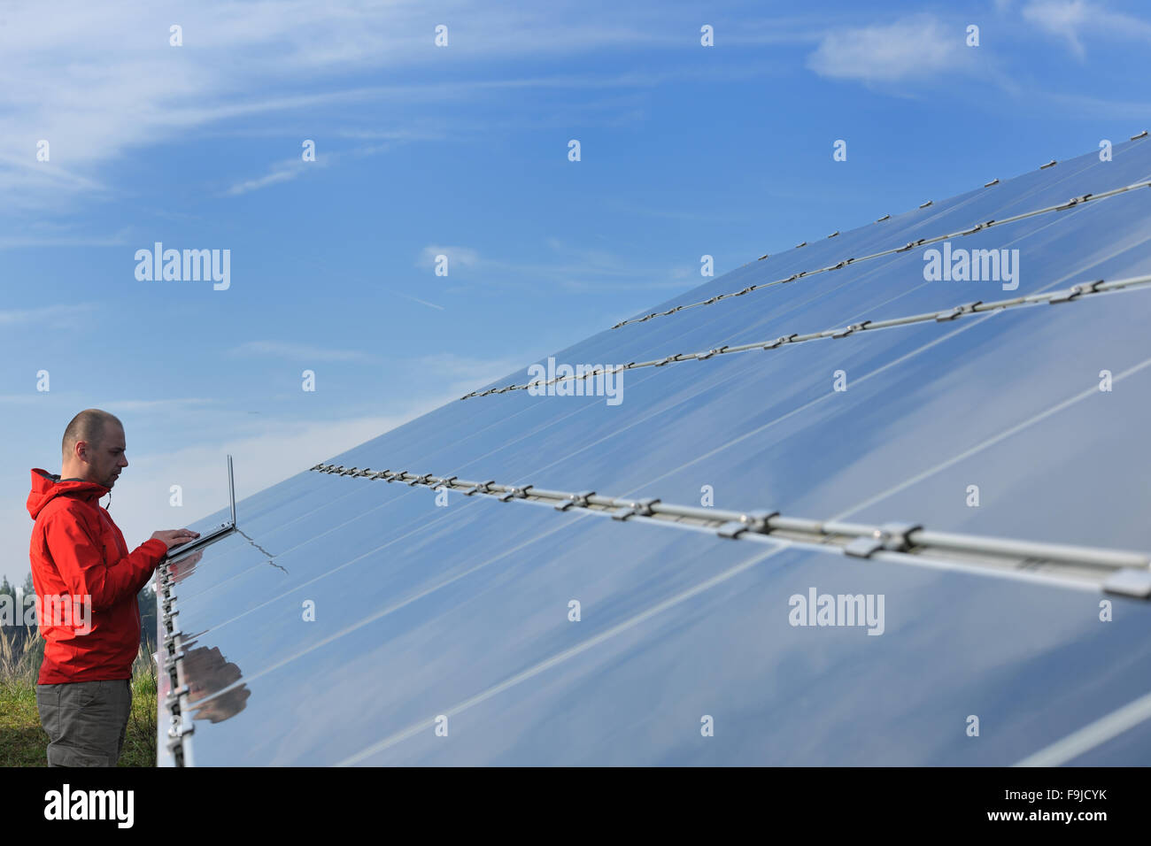 business man engineer using laptop at solar panels plant eco energy ...