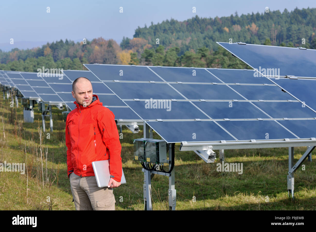 business man engineer using laptop at solar panels plant eco energy ...
