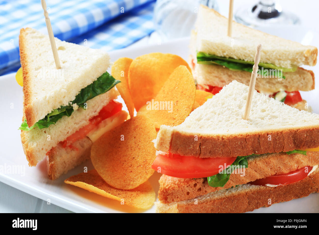 Vegetable sandwich triangles and spicy crisps Stock Photo - Alamy