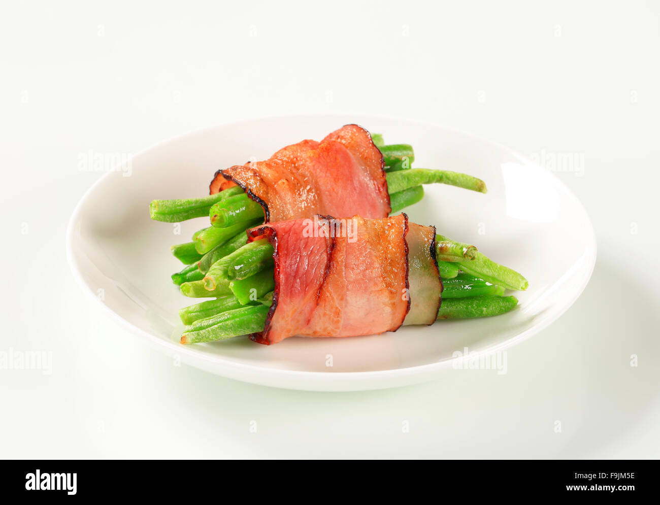 String beans wrapped in bacon Stock Photo - Alamy