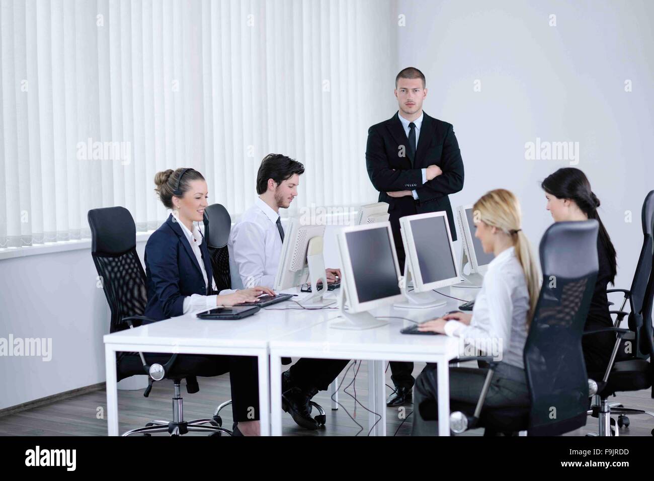 business people group with headphones giving support in help desk ...