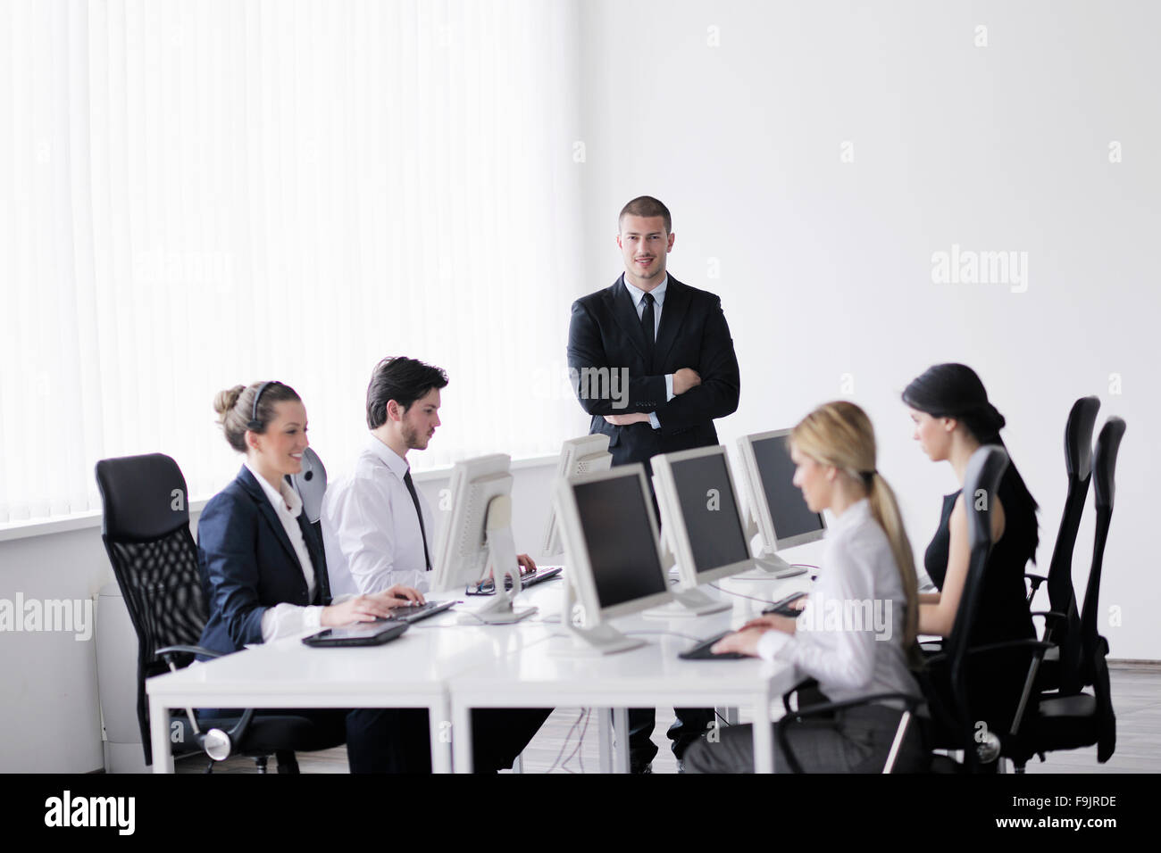 business people group with headphones giving support in help desk ...