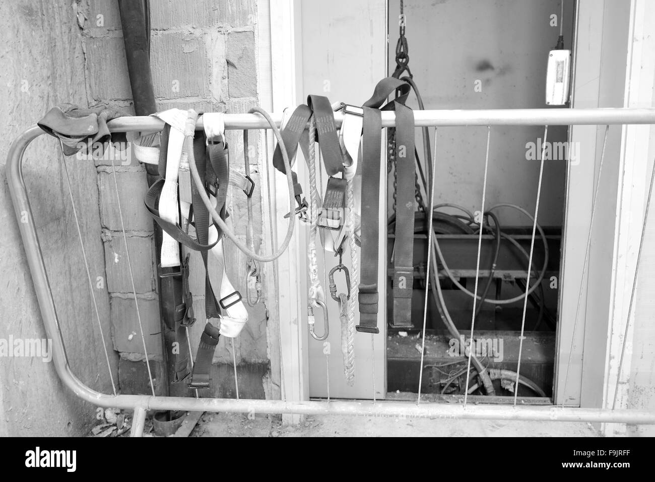 Contractors safety harness's hanging on a safety rail beside an old ...