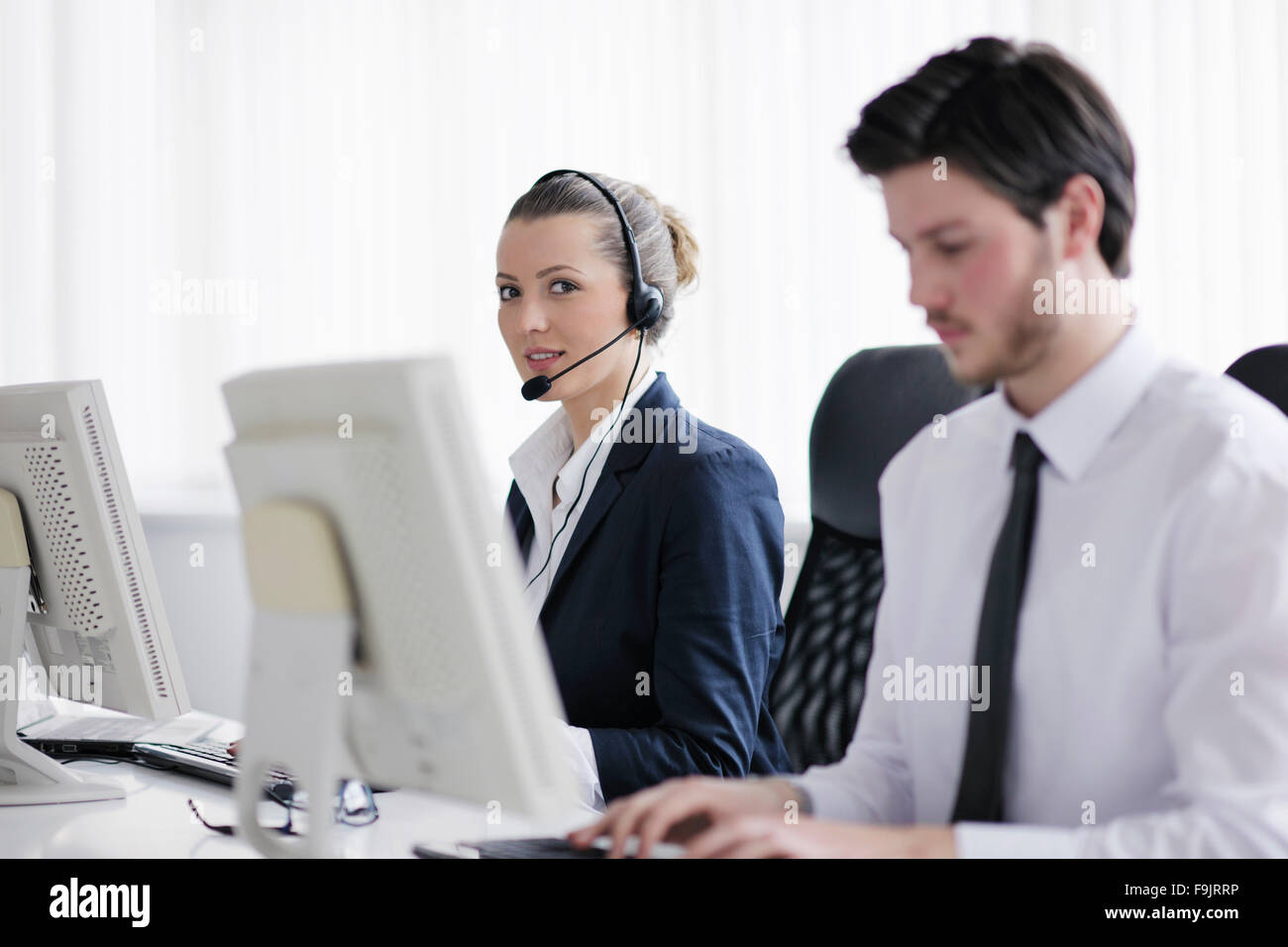 business people group with headphones giving support in help desk ...