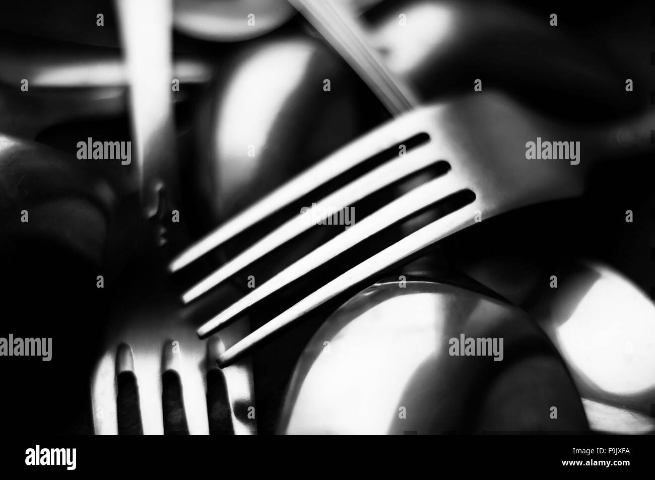 Abstract black and white photo of mixed silver forks Stock Photo - Alamy