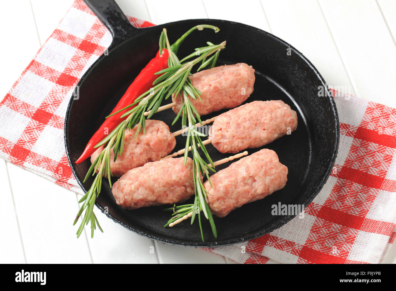 Raw minced meat kebabs on frying pan Stock Photo - Alamy