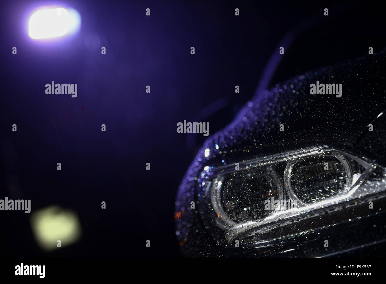 Color image of a car's headlight, covered with rain drops Stock Photo ...