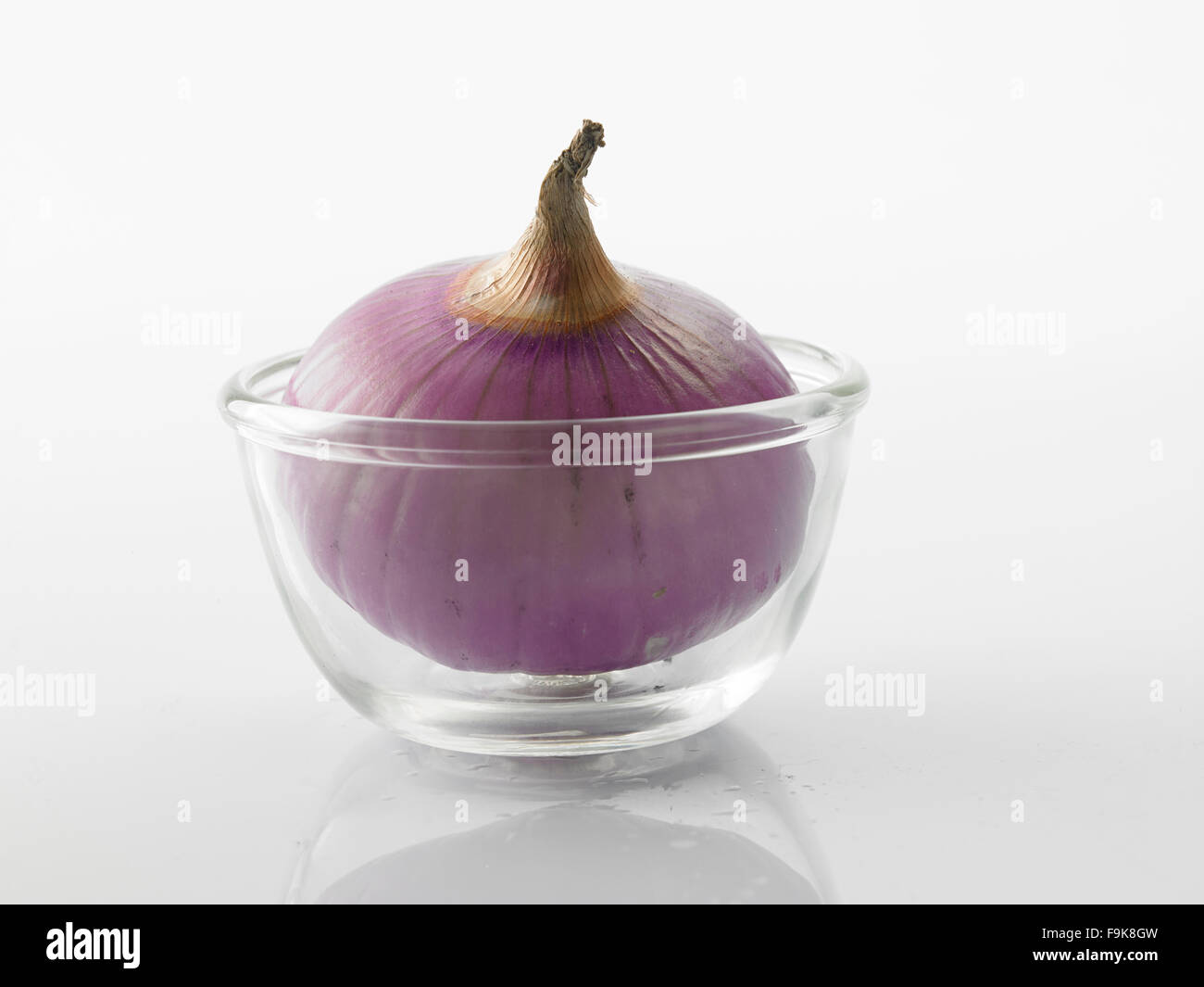 whole onion in a transparent glass bowl Stock Photo - Alamy