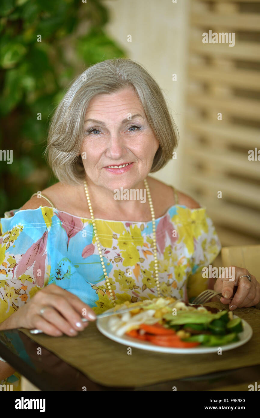 Mature woman eating breakfast hi-res stock photography and images - Alamy