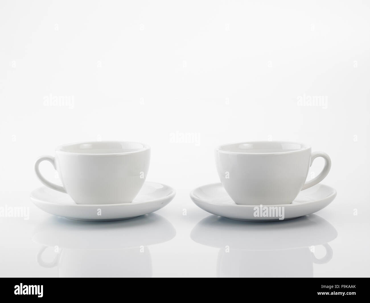 two white coffee cup on the white background Stock Photo - Alamy