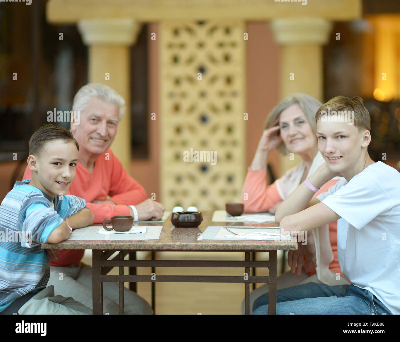 Happy family on the table Stock Photo - Alamy
