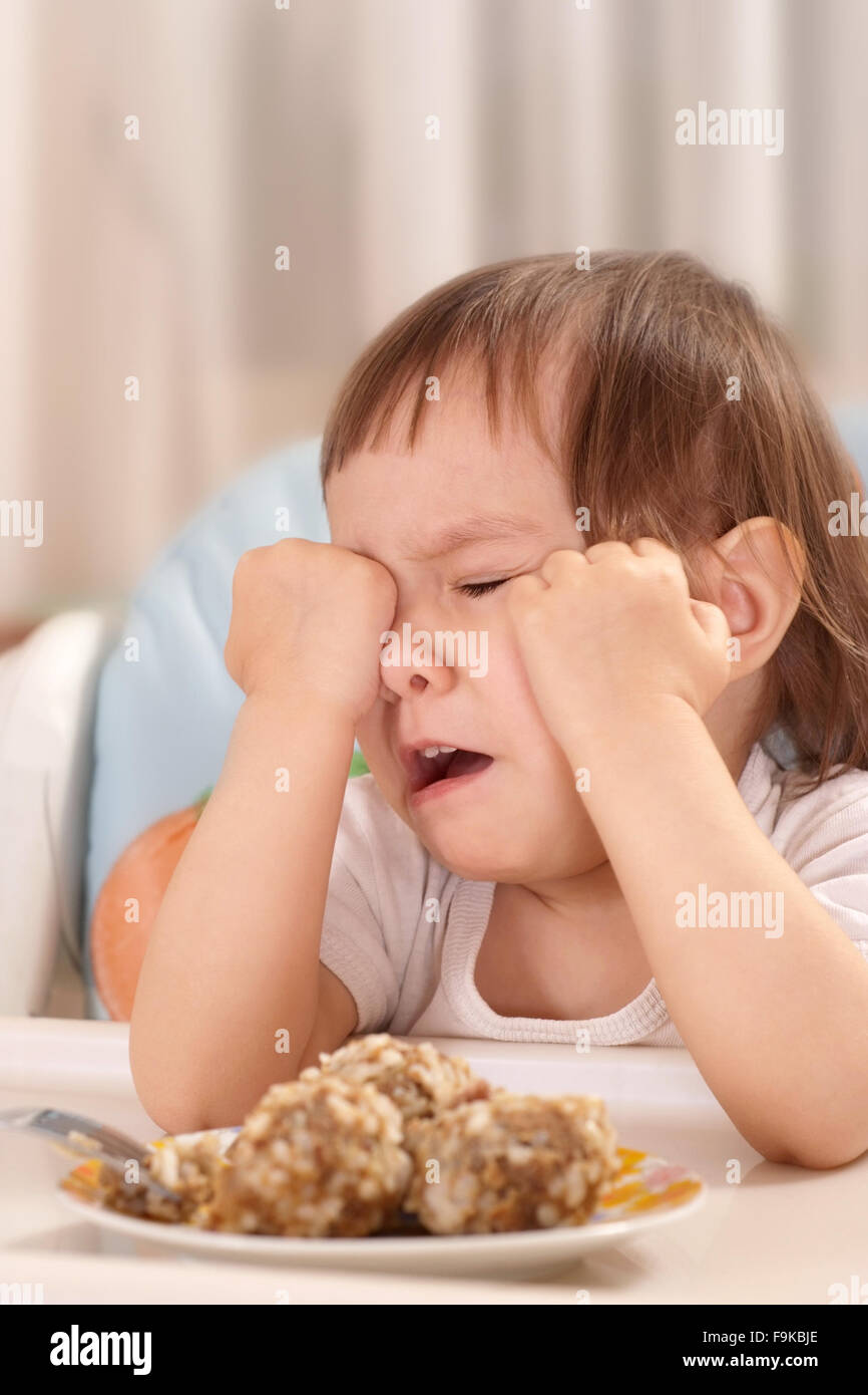 Little baby with food and crying Stock Photo - Alamy