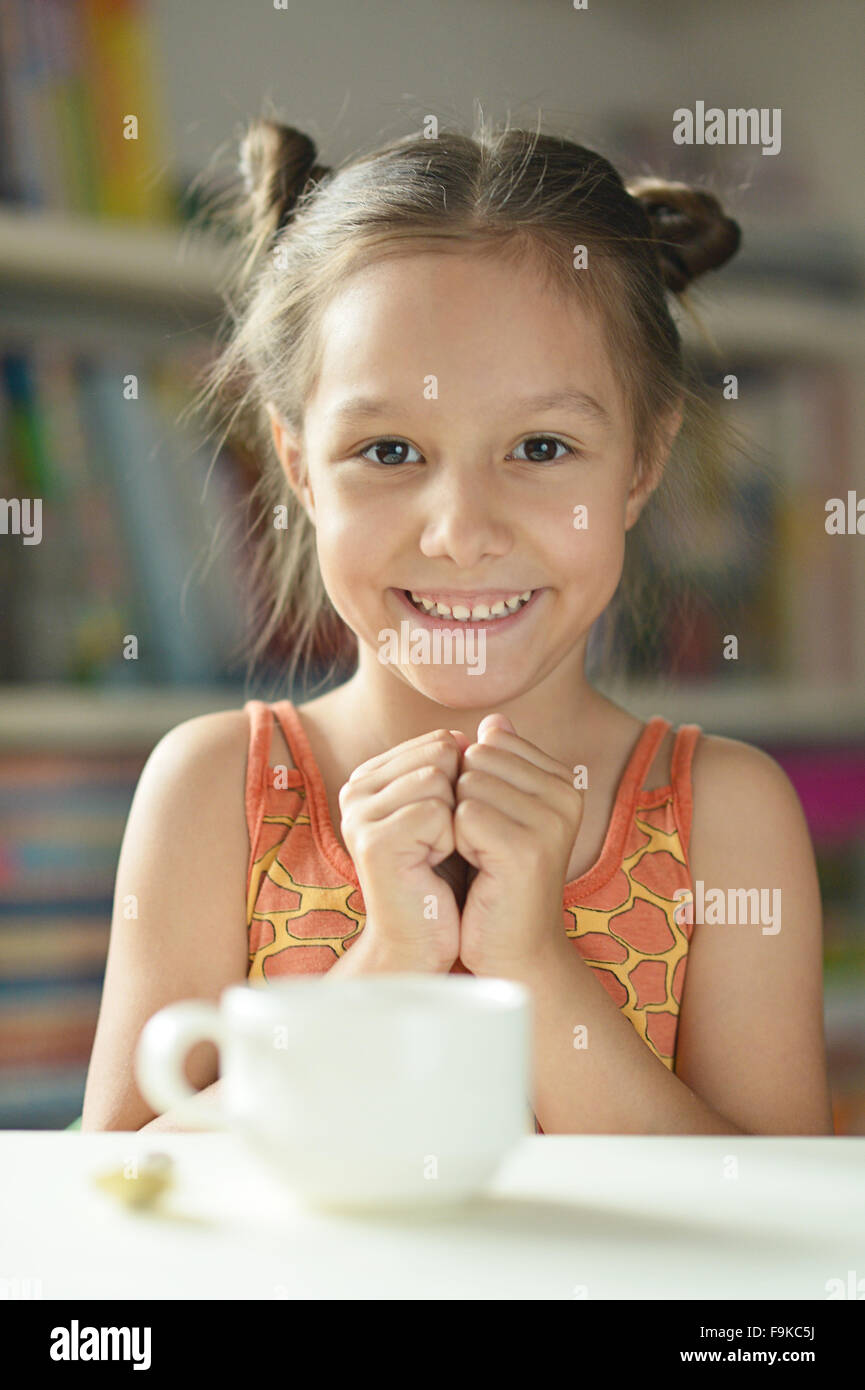 Cute little girl with cup Stock Photo - Alamy