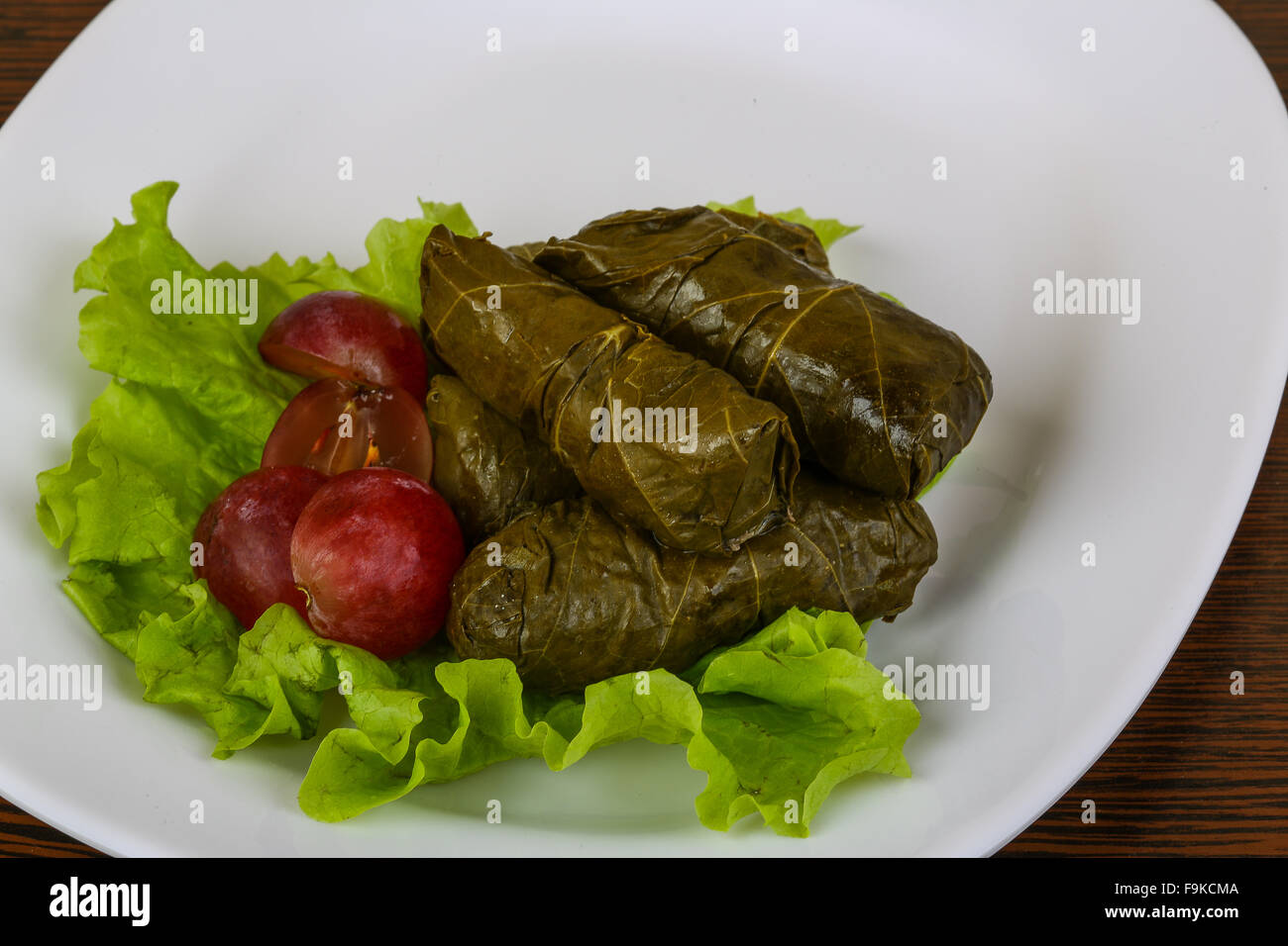 Dolma - minced meat in grape leaves with salad Stock Photo - Alamy