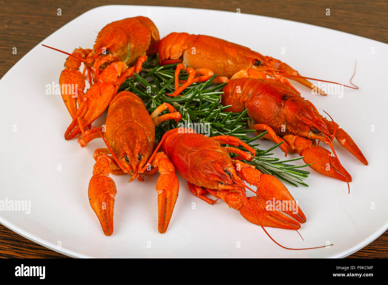 Boiled Crayfish with rosemary on the wood background Stock Photo - Alamy