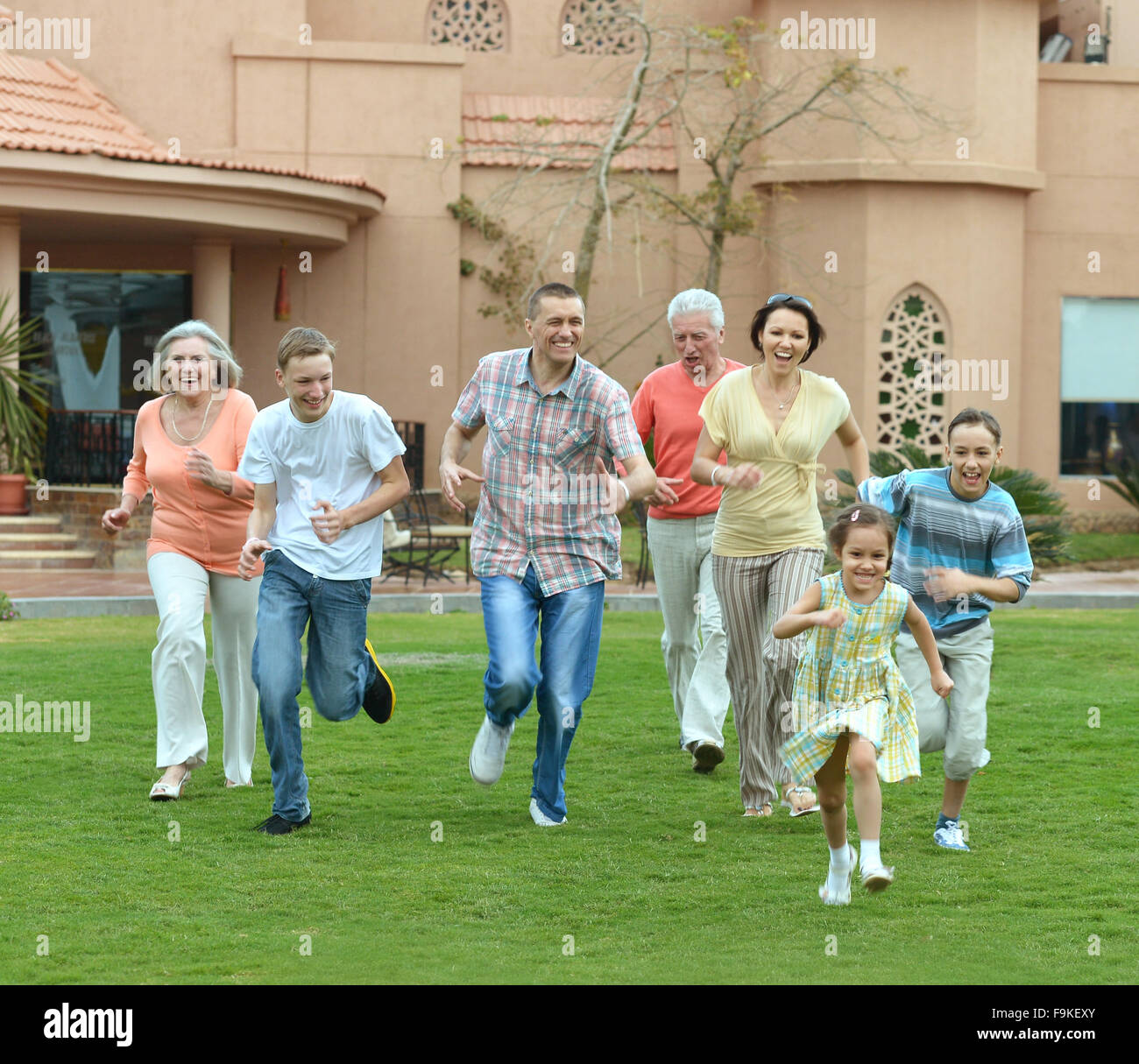 Family relaxing at resort Stock Photo - Alamy