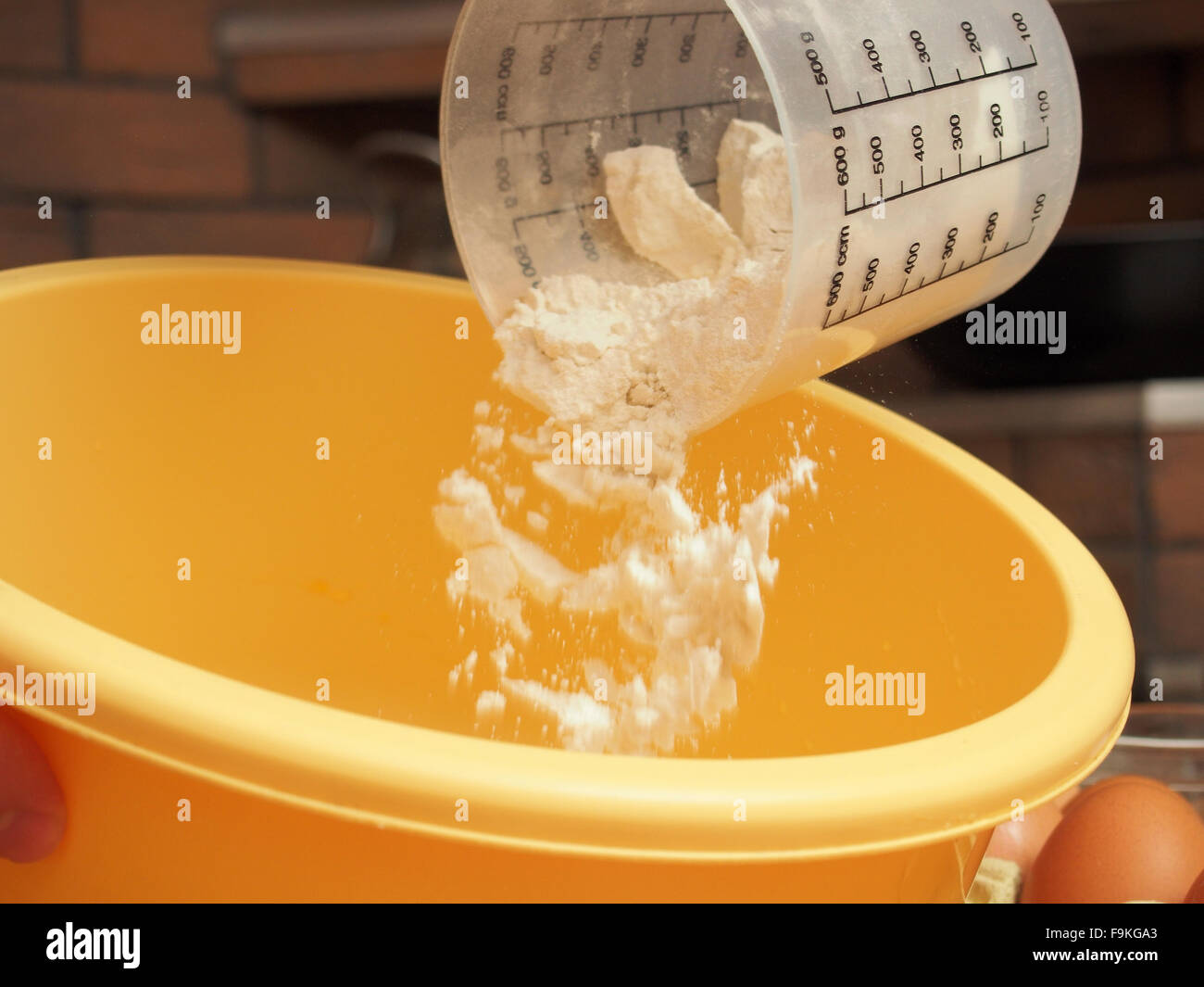 Adding flour into mixing bowl. Making yeast pancakes (crepes Stock ...