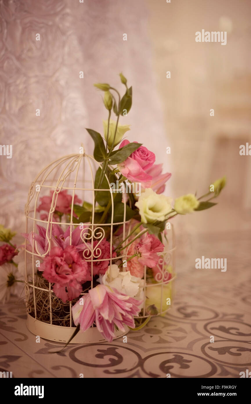 Beautiful flowers in birdcage Stock Photo - Alamy
