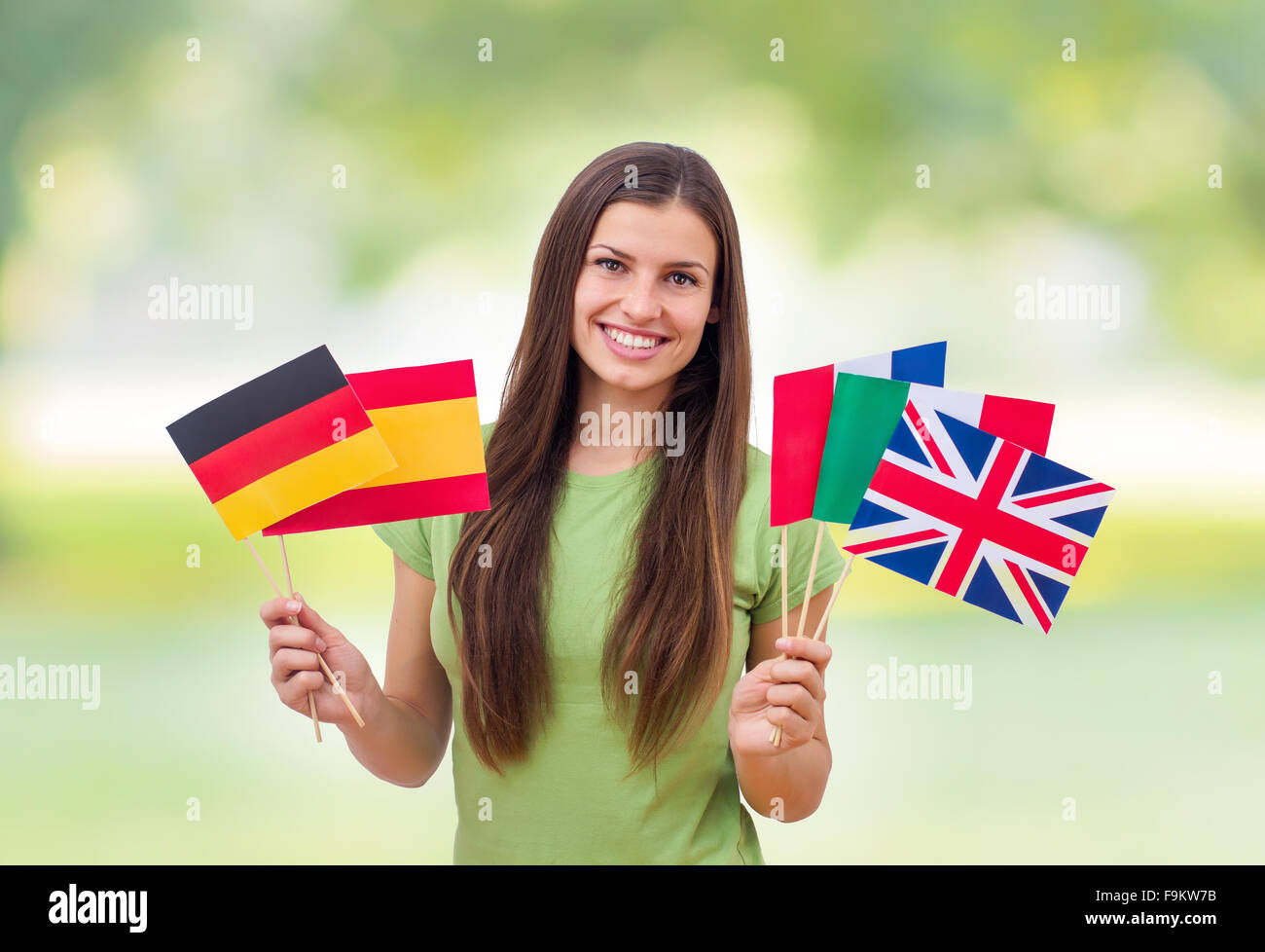 Portrait of Happy beautiful student female with international flags ...