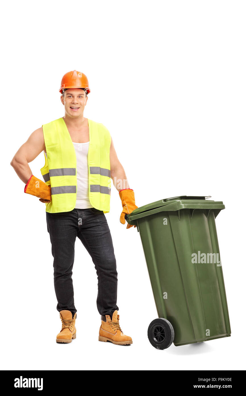 Full length portrait of a young male waste collector posing next to a ...