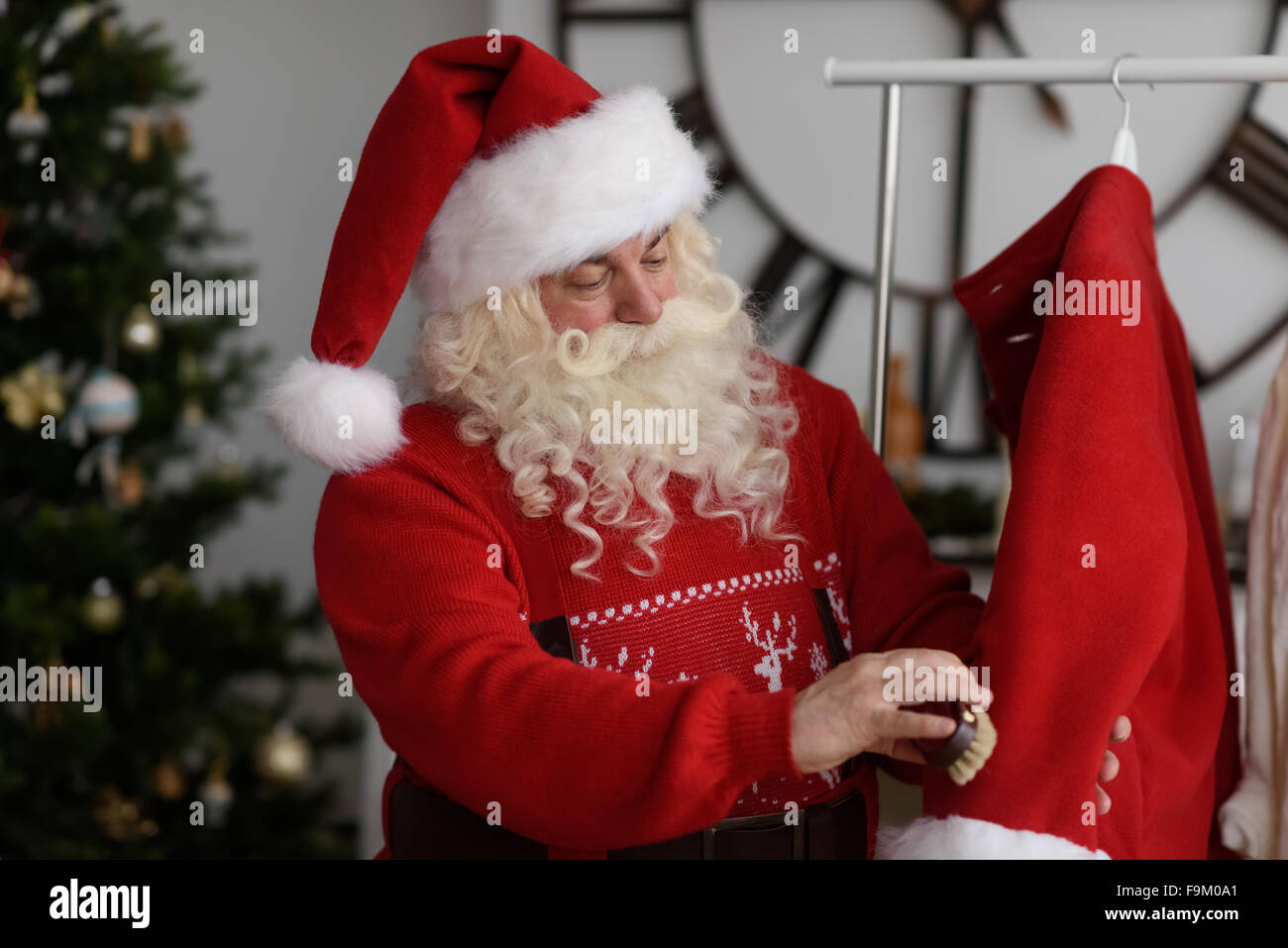 Santa Claus at Home cleaning his Costume, Preparing for Work Stock ...