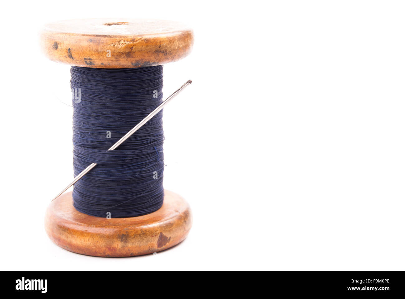 spool of thread with needle Stock Photo - Alamy