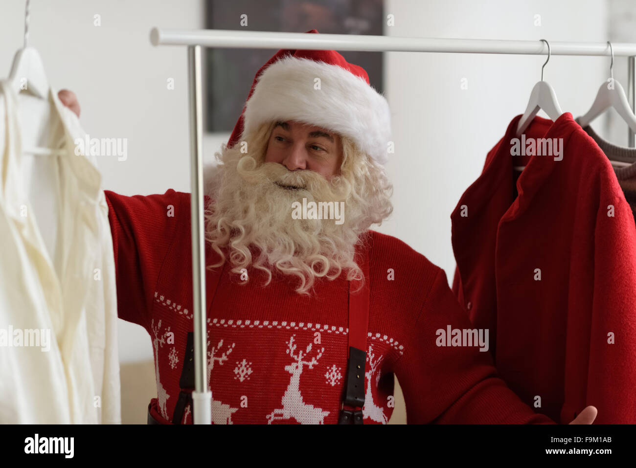 Santa Claus at Home Putting on Costume Stock Photo - Alamy