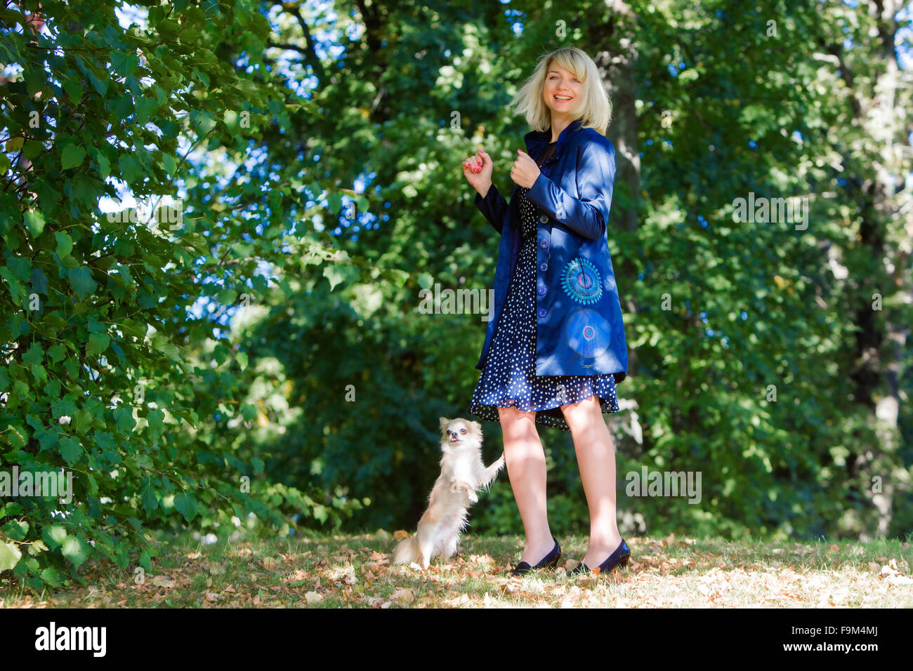 Lady gives commands to her little friend Stock Photo - Alamy