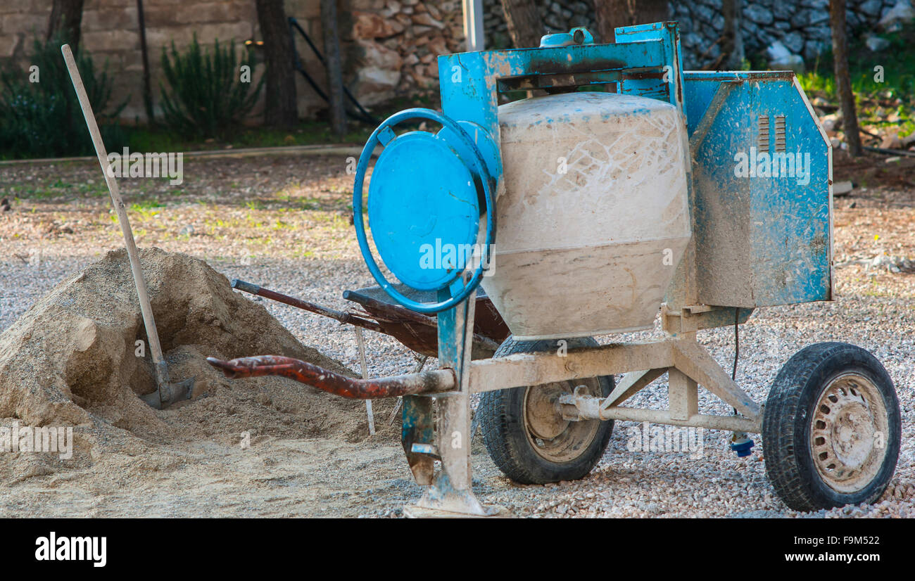 Concrete mixer machine at construction site, tools and sand Stock Photo ...