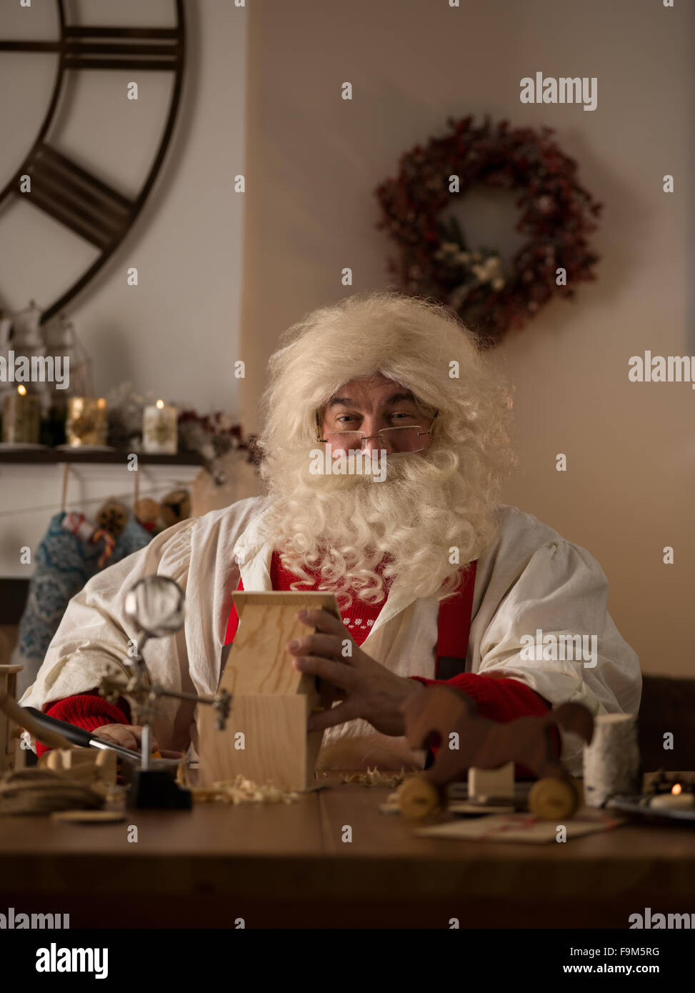 Santa Claus Working at Home. Making Toys for Children Stock Photo - Alamy