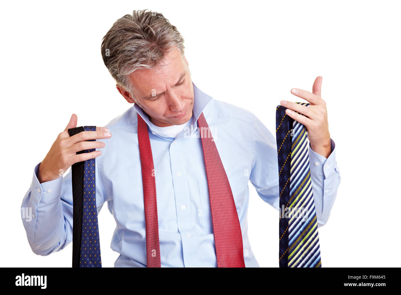 Elderly business man holding many different ties in his hands Stock ...
