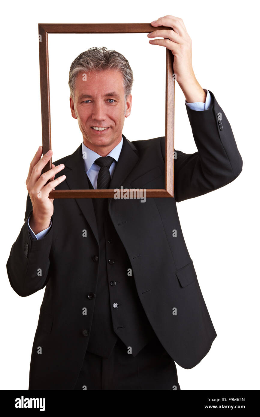 Smiling senior business man looking through empty frame Stock Photo - Alamy