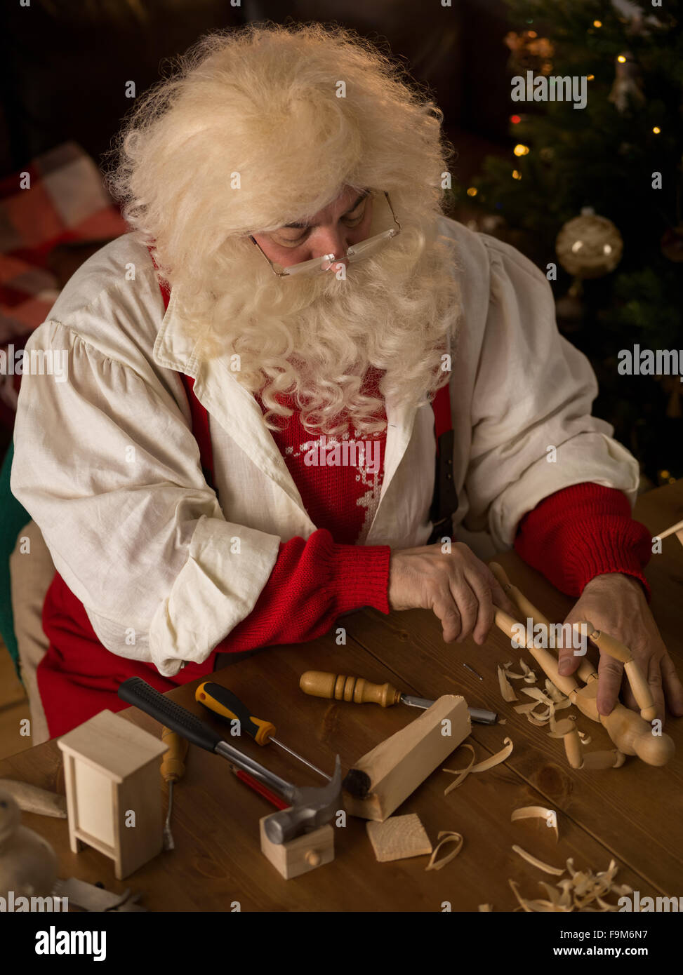 Santa Claus Working at Home. Making Toys for Children Stock Photo - Alamy