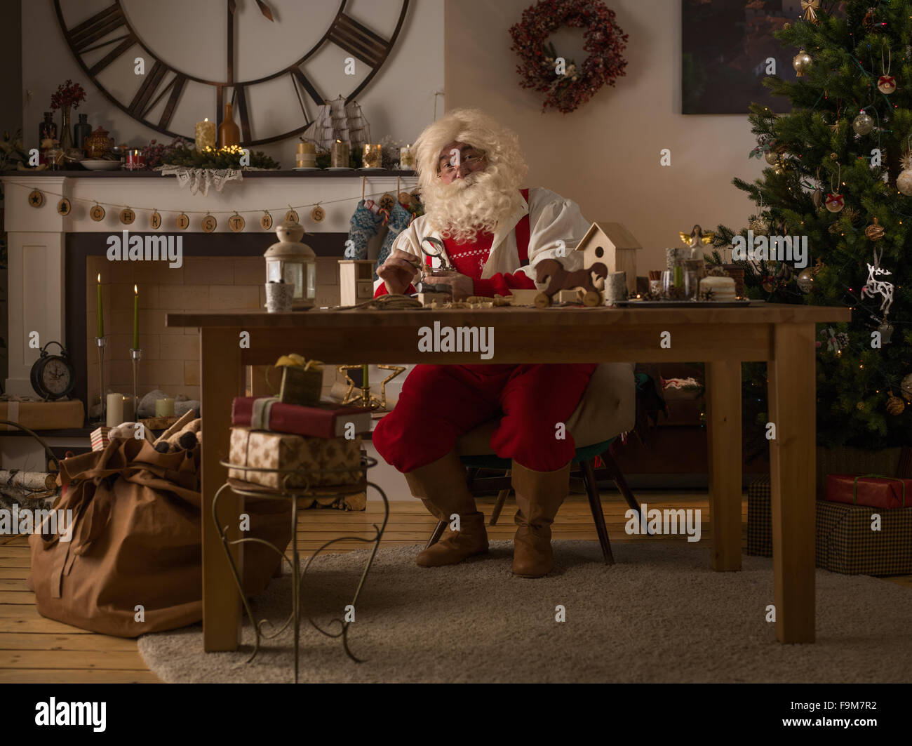 Santa Claus Working at Home. Making Toys for Children Stock Photo - Alamy