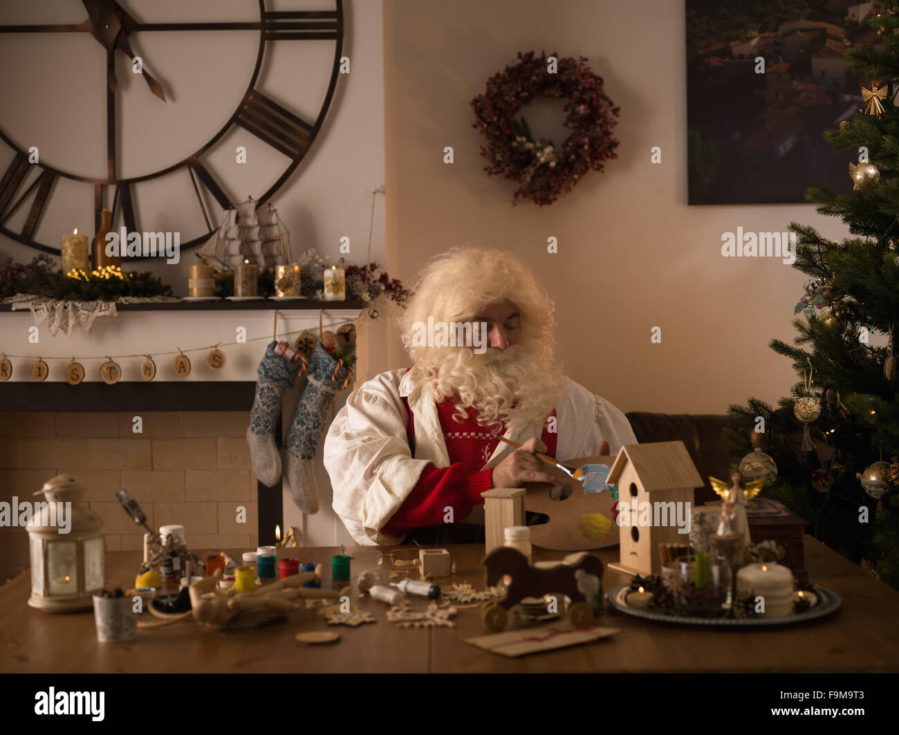 Santa Claus Working at Home. Making Toys for Children Stock Photo - Alamy