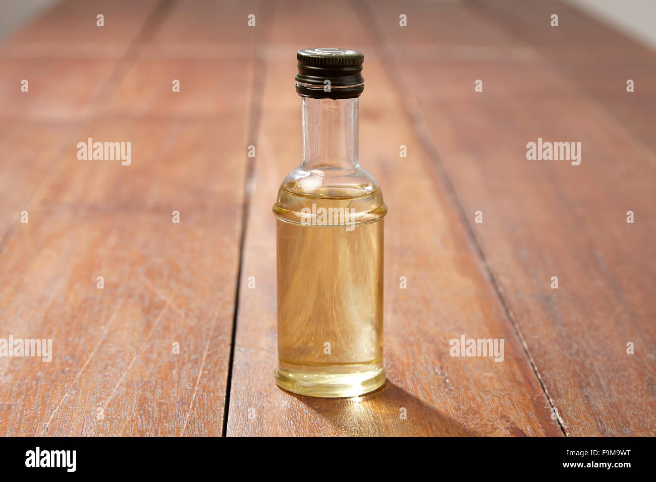 Oil In Glass Bottle On A White Background Stock Photo - Alamy