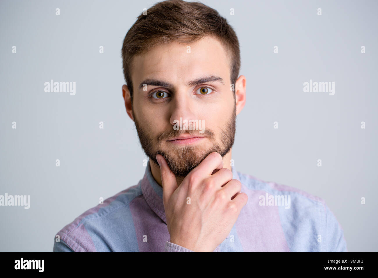 Portrait of handsome thoughtful young man with beard in shirt Stock ...