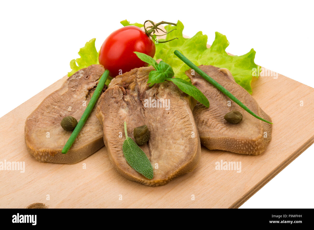 Beef tongue with herbs isolated Stock Photo - Alamy