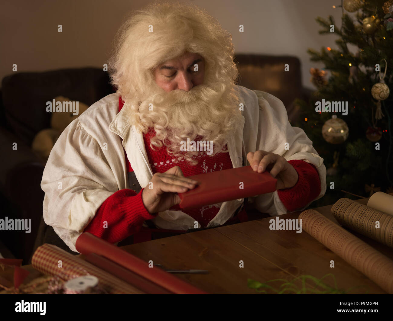 Santa Claus Working at Home. Wrapping Gifts for Children Stock Photo ...