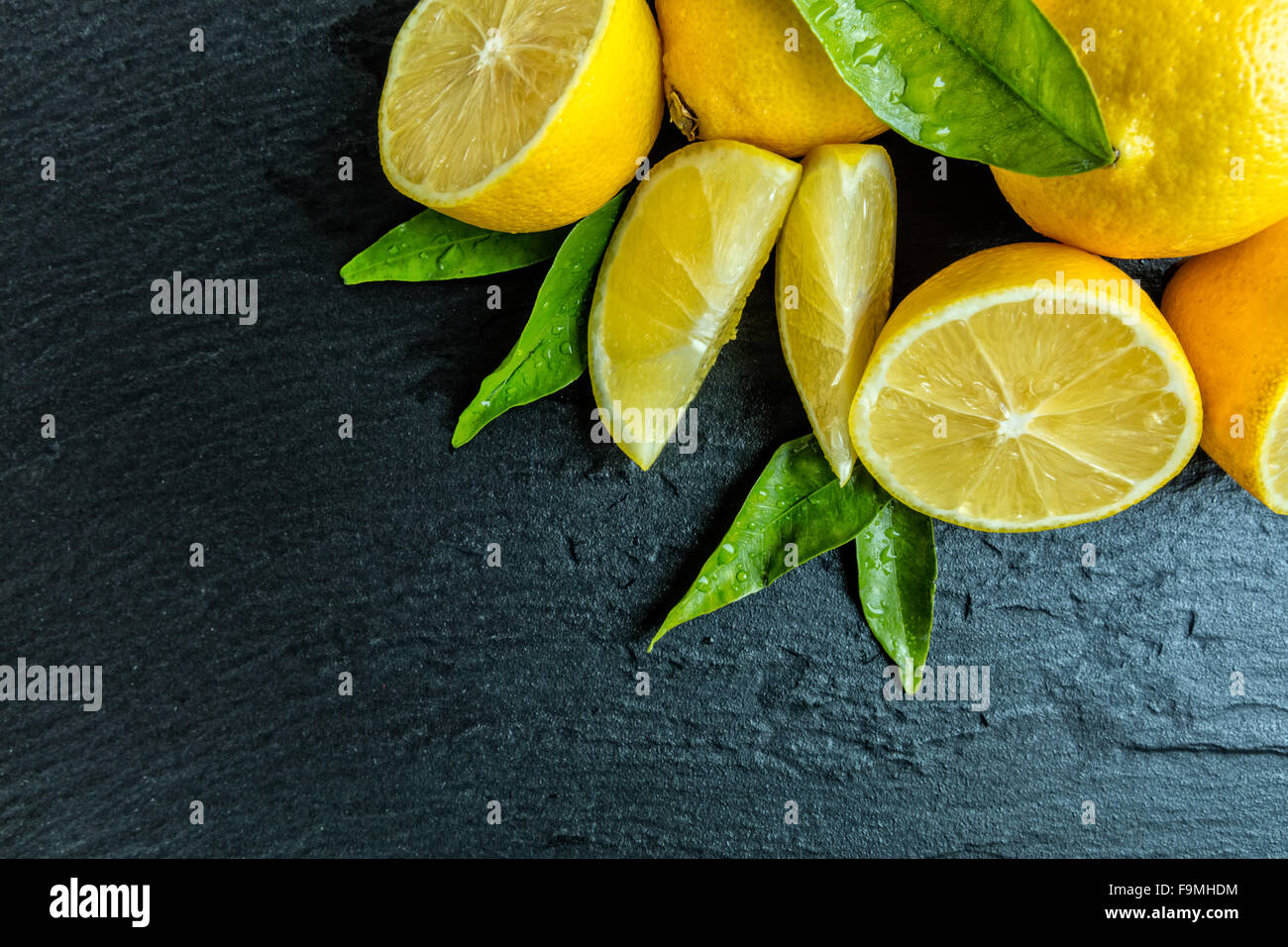 Fresh lemon on black stone Stock Photo - Alamy